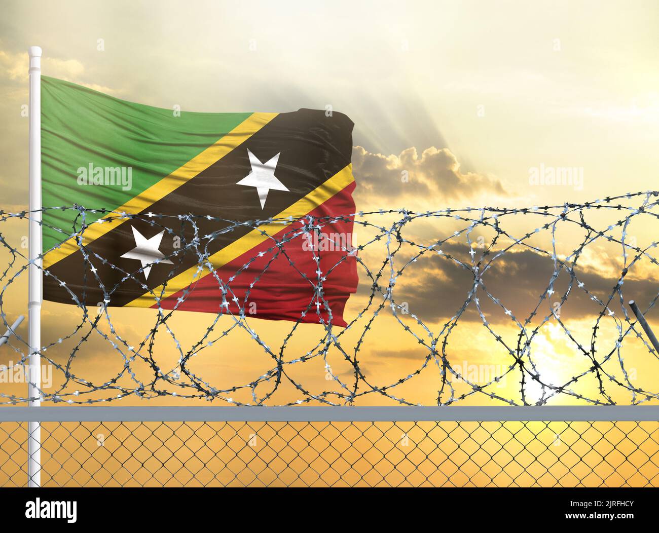 Flagpole with the flag of Saint Kitts and Nevis against the sky and ...