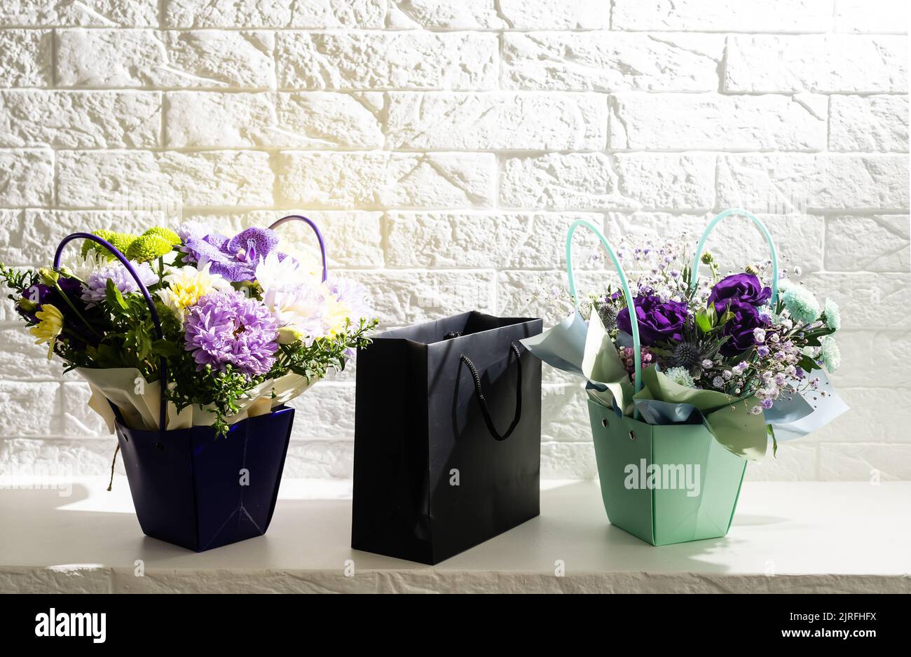 black empty paper bags and bouquets. Blank wall Stock Photo - Alamy