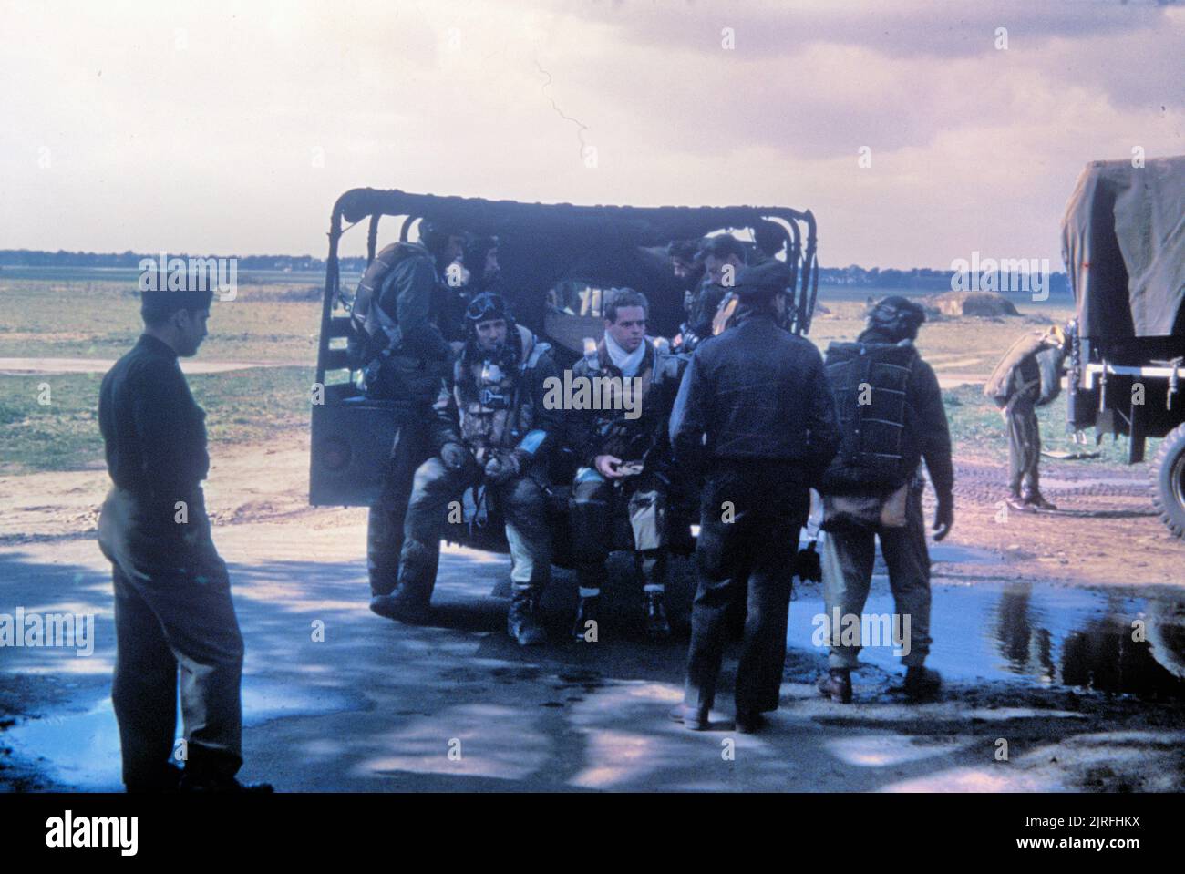 Personnel of the 359th Fighter Group sit on the back of a crew truck at ...