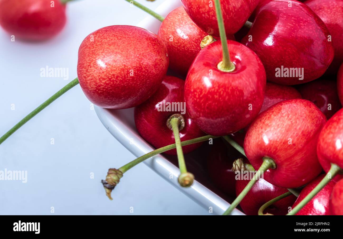 Cherries in close-up. Red fruit with green petioles. The structure of ...