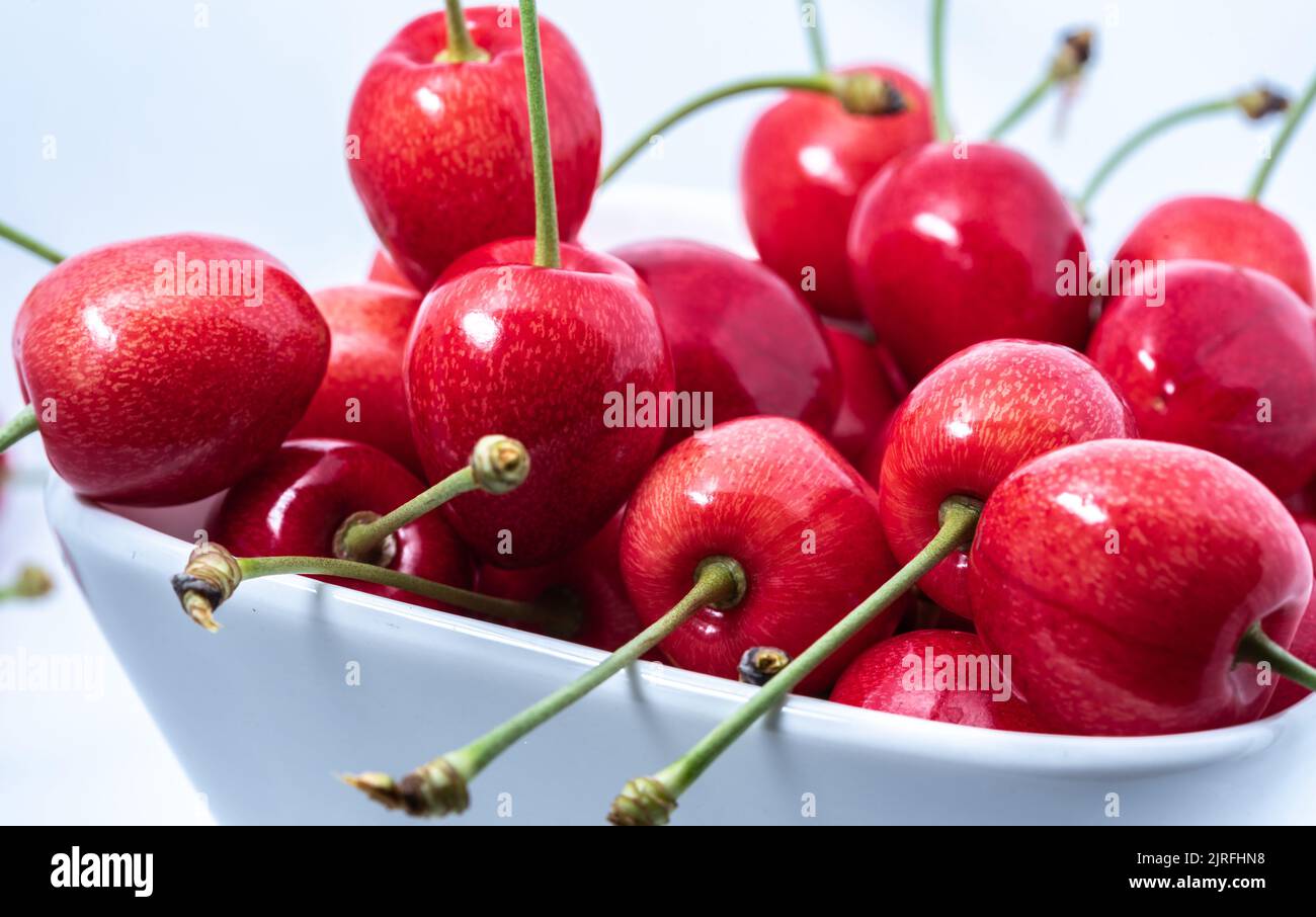 Cherries in close-up. Red fruit with green petioles. The structure of ...