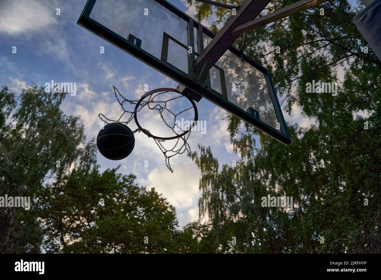 Street basketball ball falling into the hoop. Concept of success ...