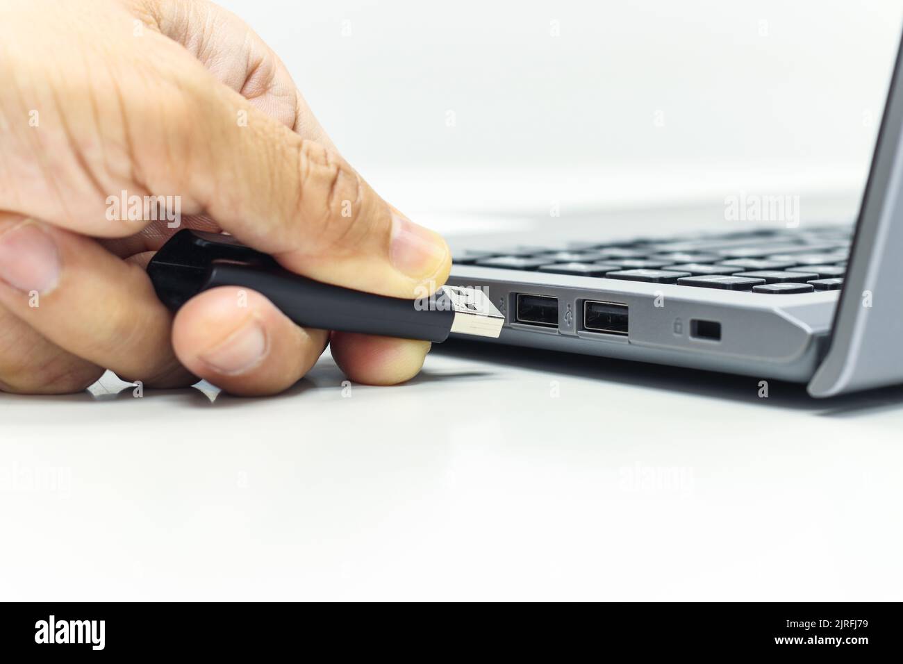 Hand of Businessman push the USB Drive to USB Port for Laptop transfer ...