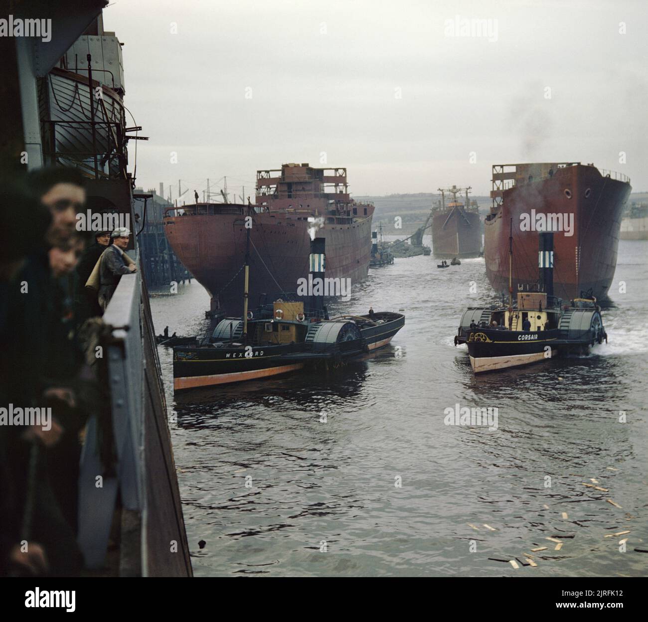 Shipbuilding in Belfast, 1943 Two recently launched ships being towed ...
