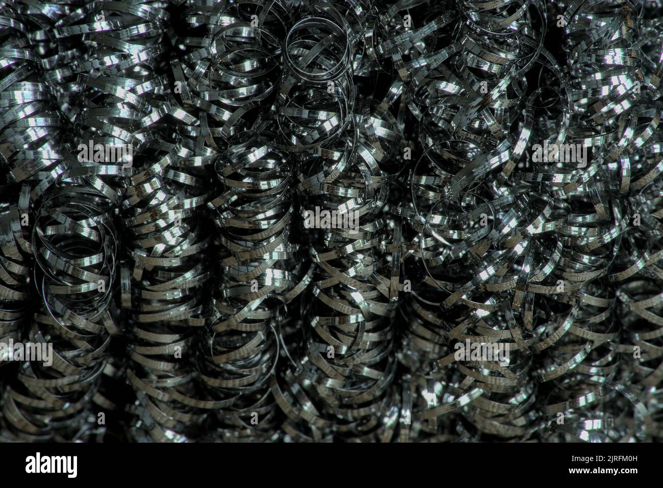steel tangled spiral metal fibers background, macro photography close ...