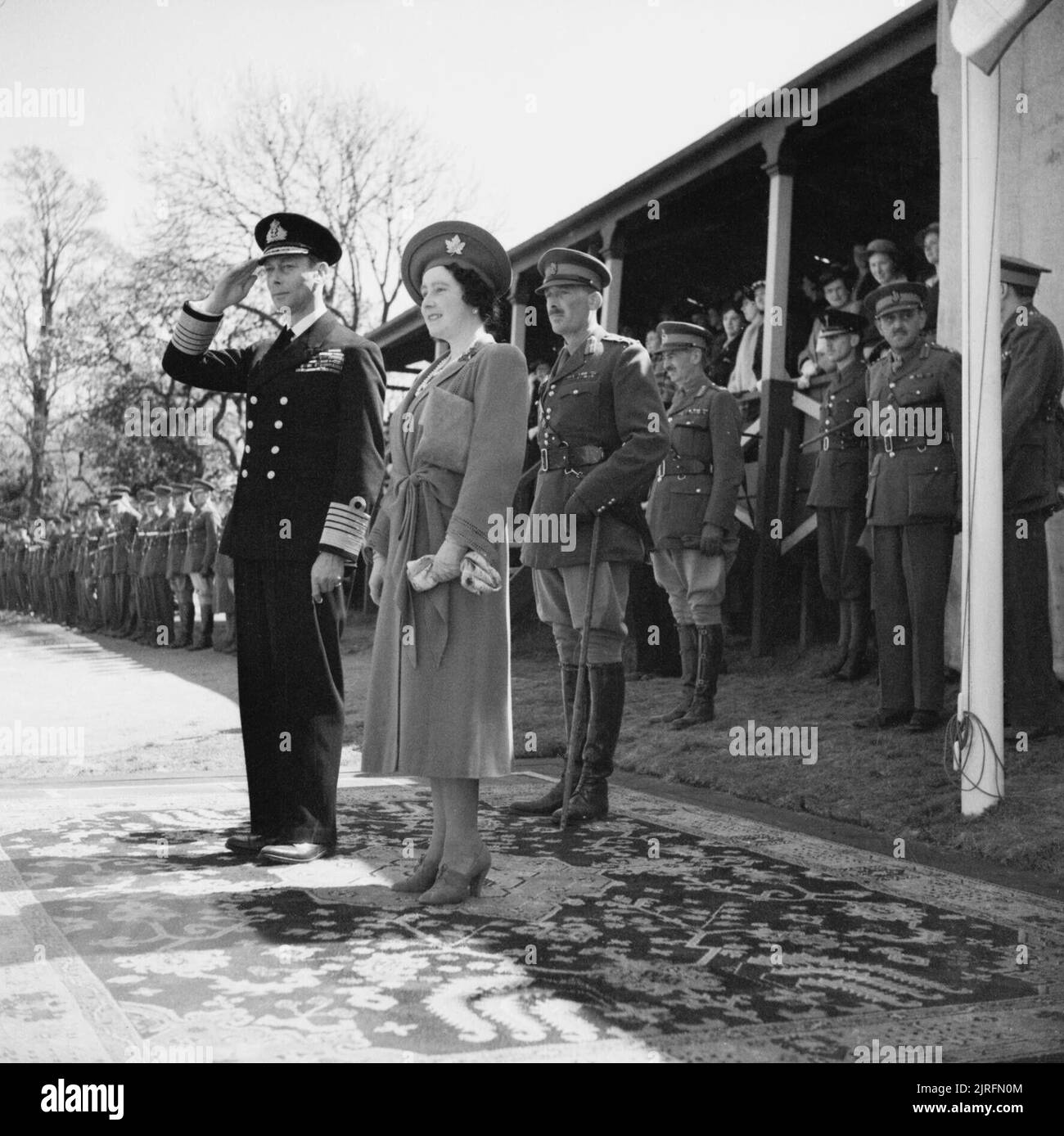 HM King George VI and Queen Elizabeth take the salute at a march past ...