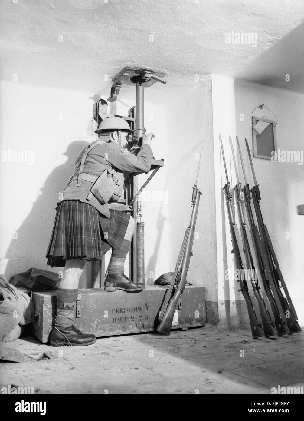 A soldier from the Cameron Highlanders looks through a periscope in the ...