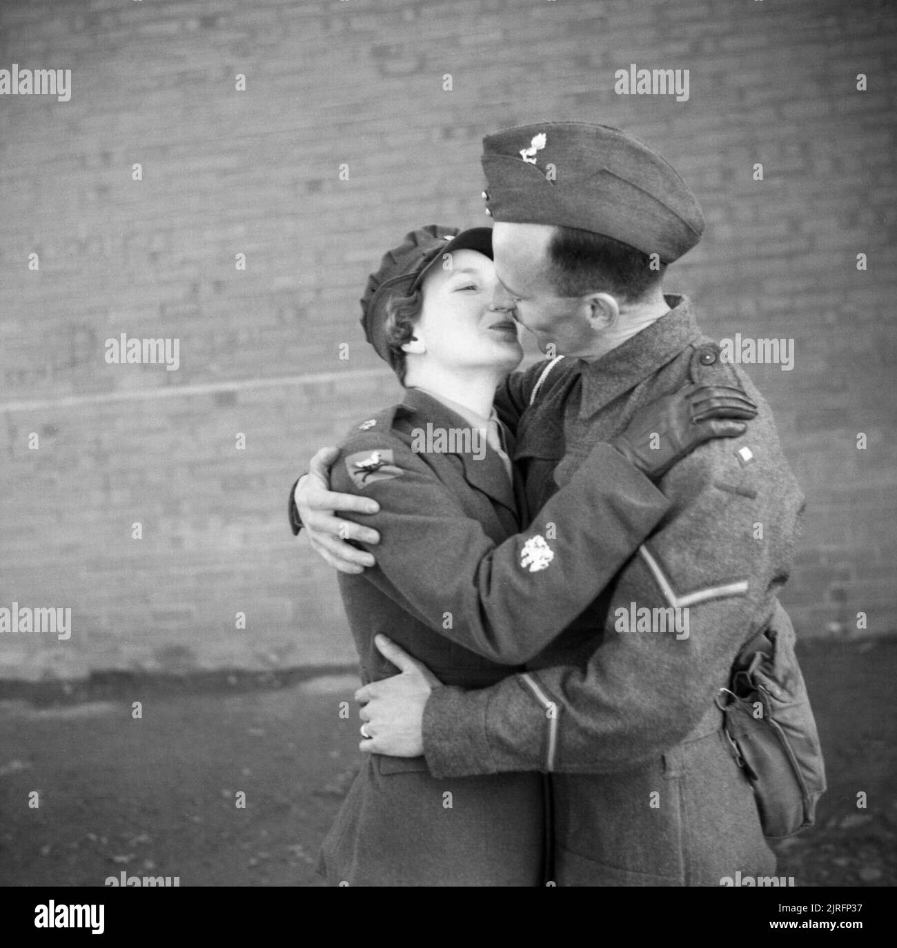 Staff Sergeant-Major Twist of the ATS embraces and kisses her husband ...