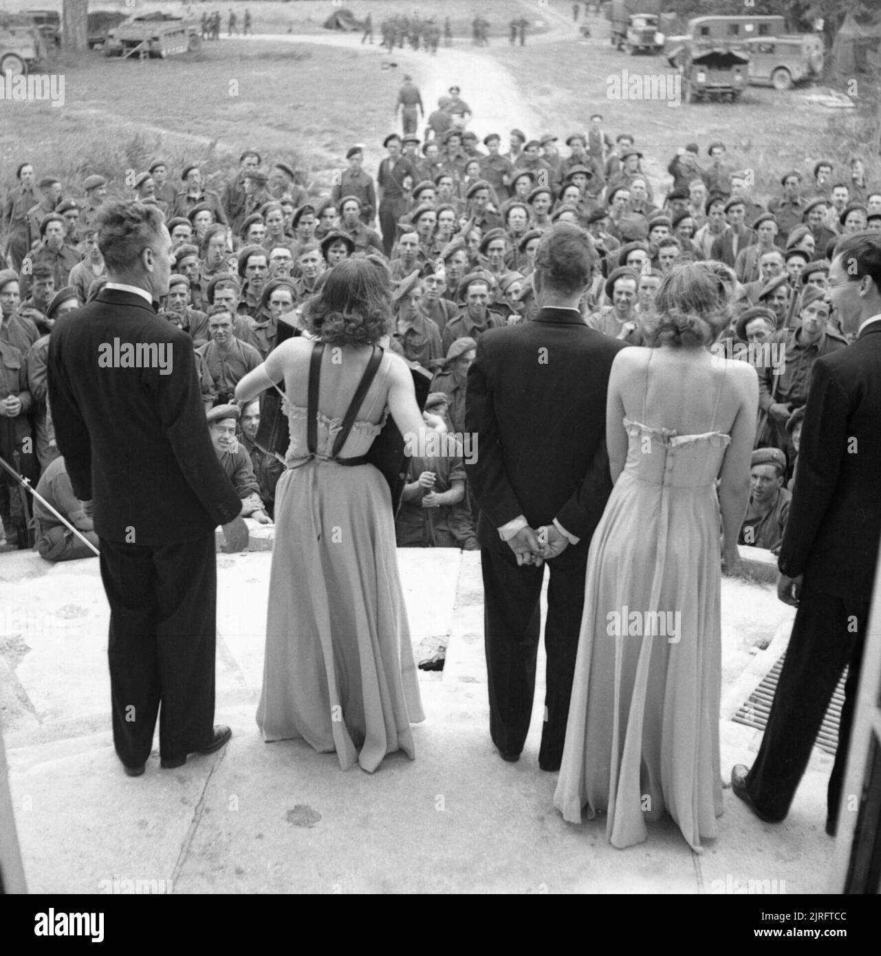 An ENSA concert party entertaining troops from the steps of a chateau ...