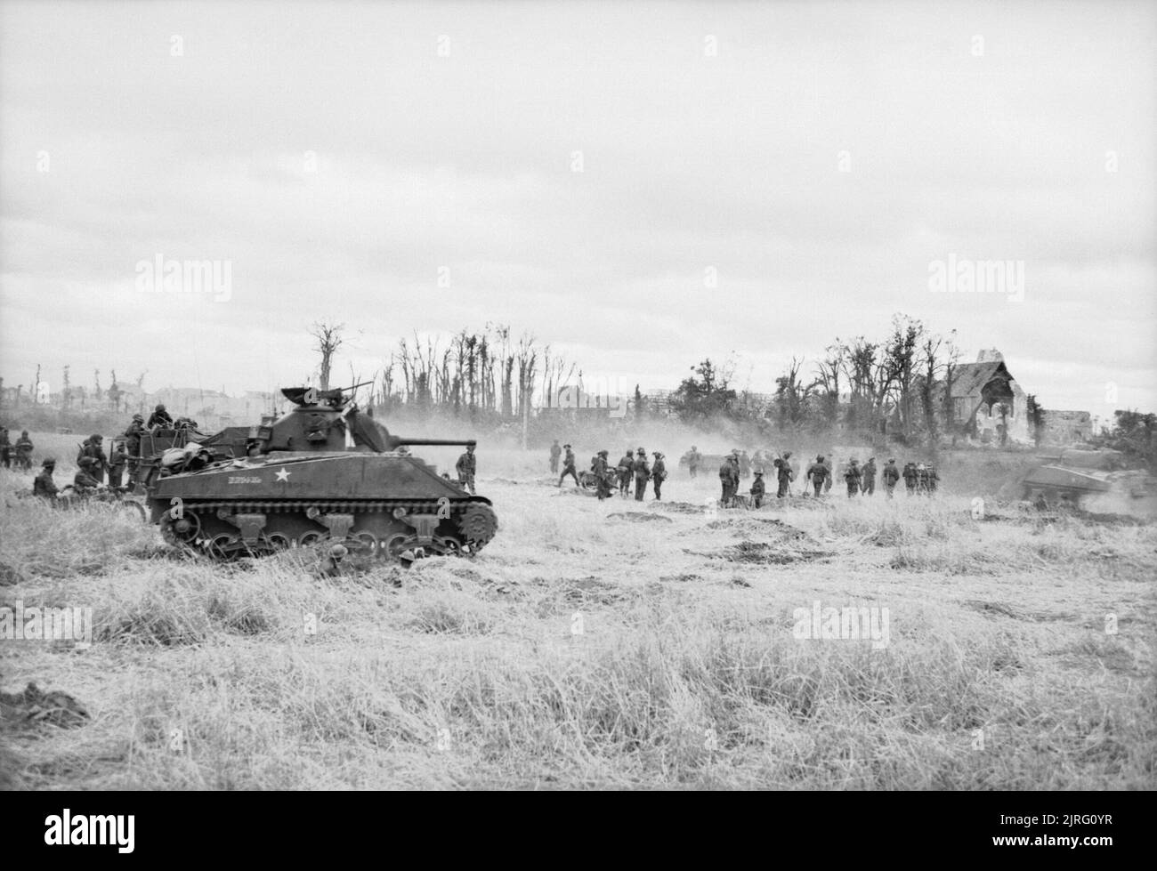 British Sherman tanks and infantry during the advance on Caen, Normandy ...