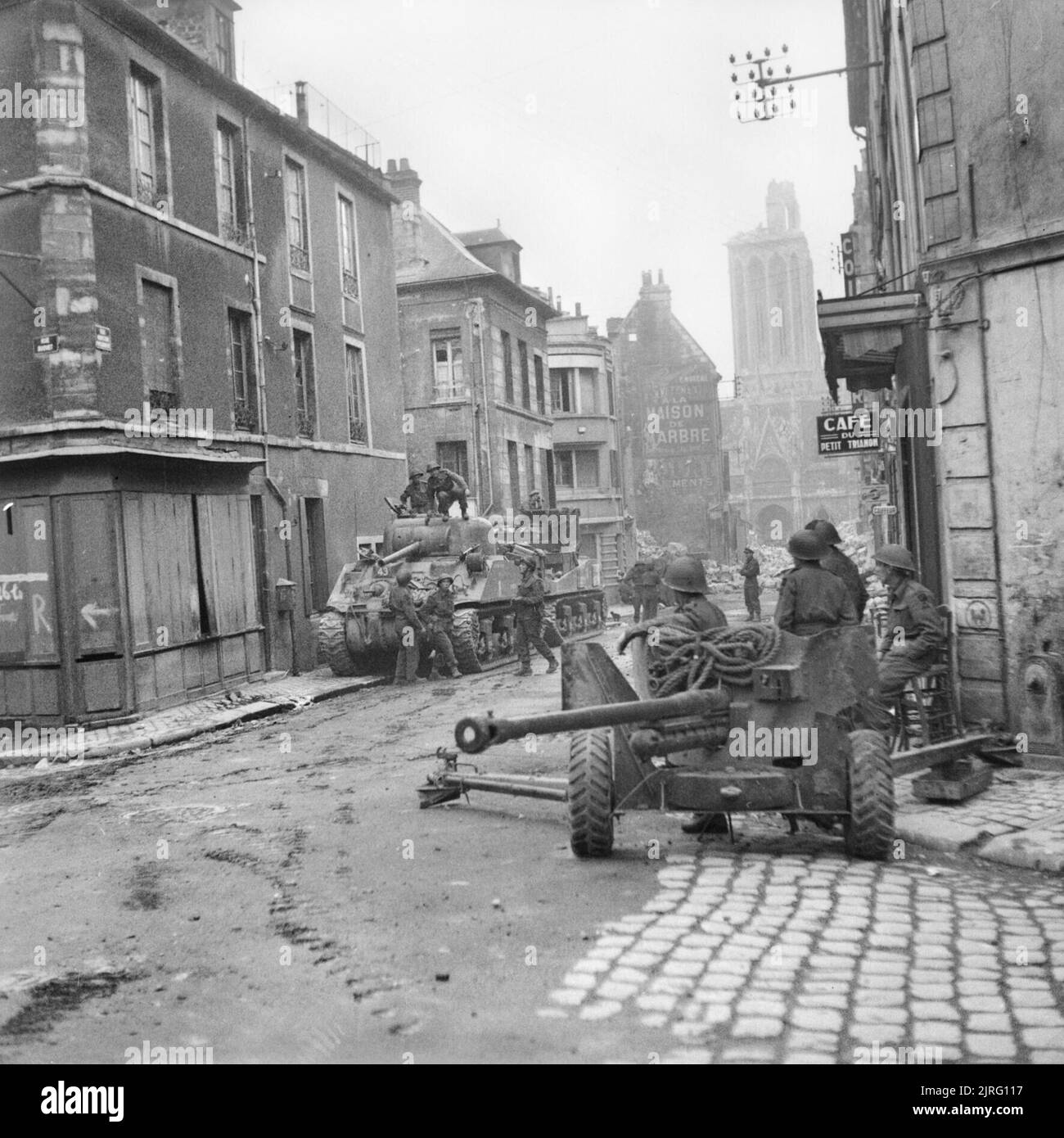 British Sherman tanks and a 6-pdr anti-tank gun in the centre of Caen ...