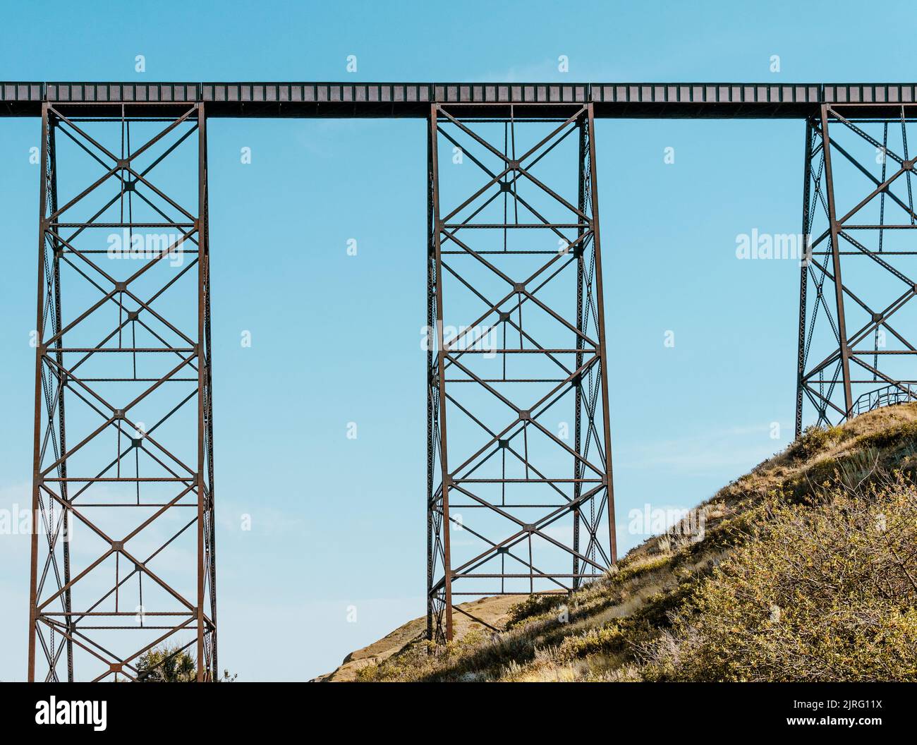A tall train bridge viaduct engineered with iron steel trusses and ...