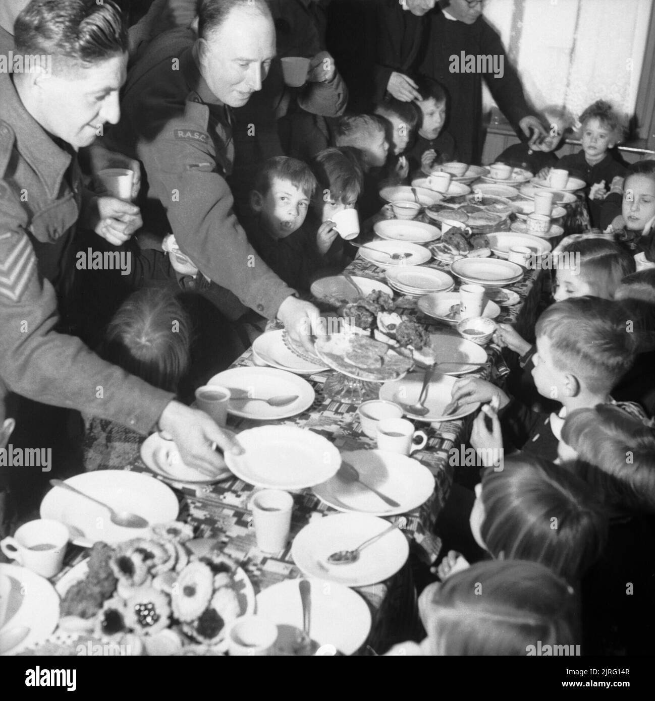 British soldiers serving food to Dutch children at a St Nicholas Day ...