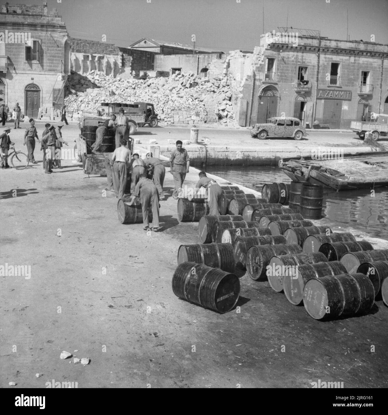 The British Army on Malta 1942 Soldiers loading oil drums onto a lorry ...