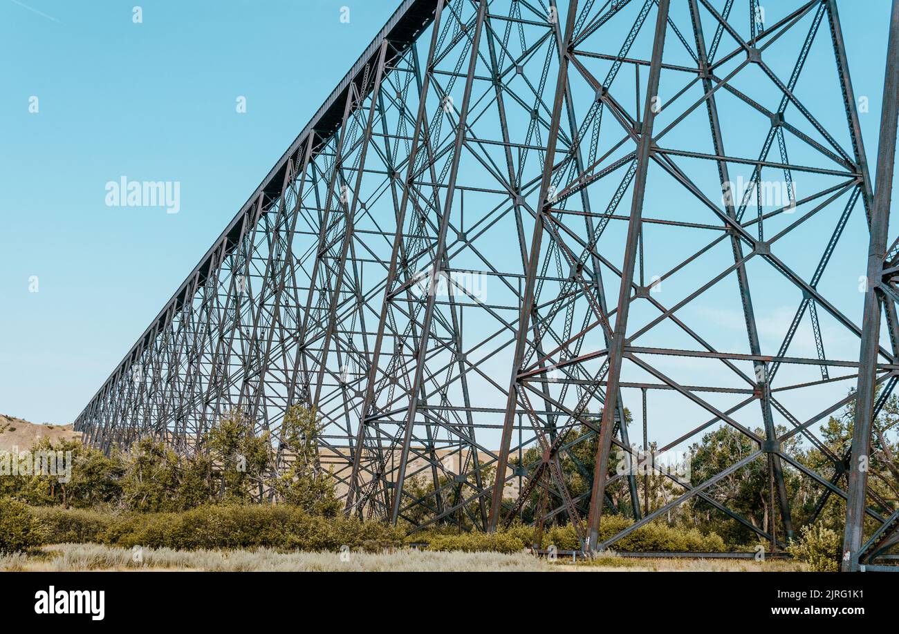 A tall train bridge viaduct engineered with iron steel trusses and ...