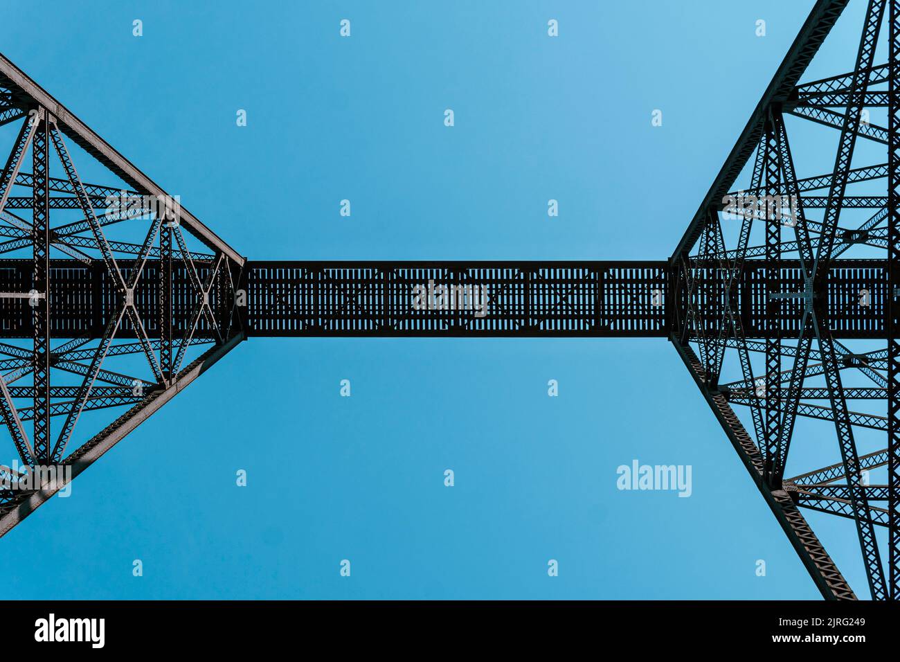A tall train bridge viaduct engineered with iron steel trusses and ...