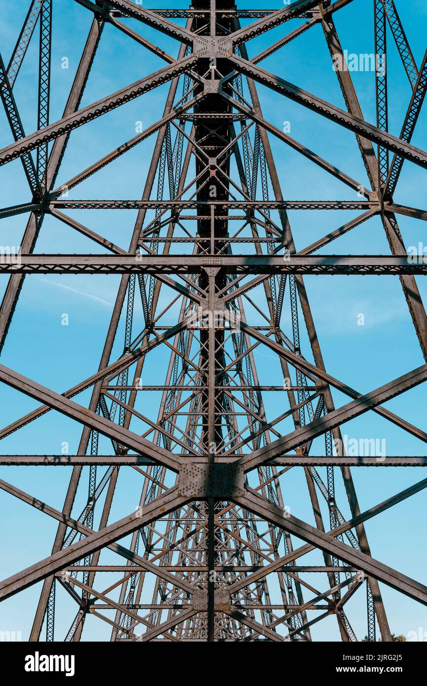 A tall train bridge viaduct engineered with iron steel trusses and ...