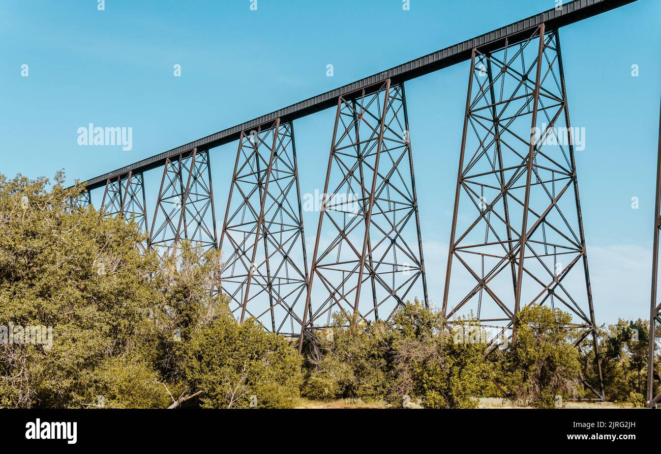 A tall train bridge viaduct engineered with iron steel trusses and ...