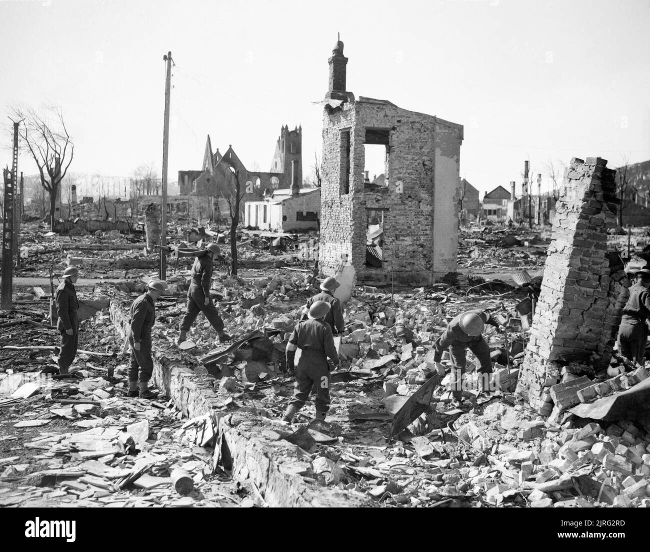 Troops pick through the ruins of Namsos in Norway after a German air ...