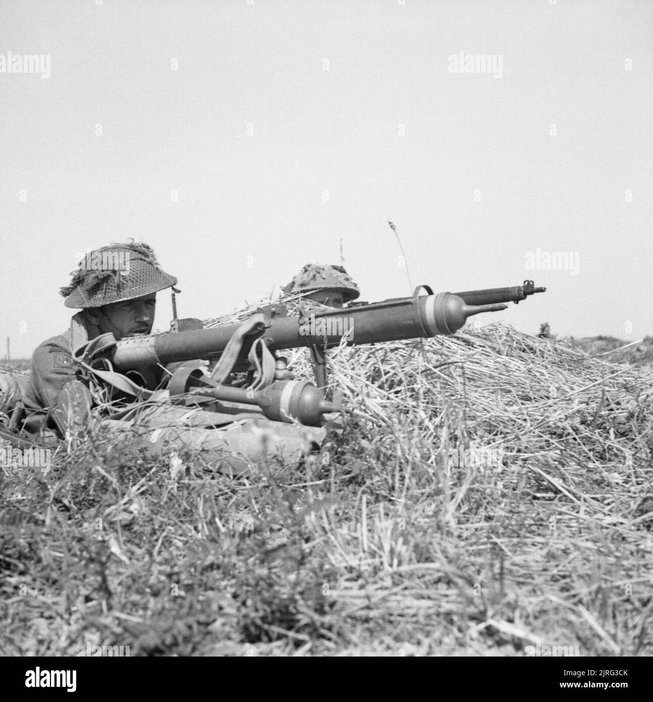 A British infantryman prepares to fire a PIAT anti-tank weapon ...