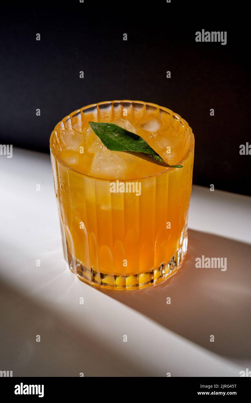 glass of orange juice with ice on table Stock Photo - Alamy