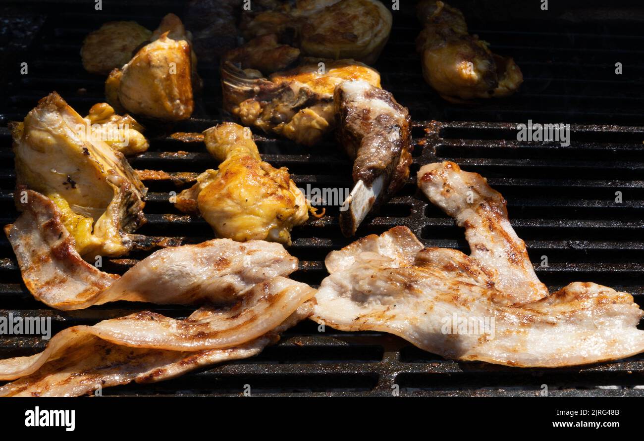 Aerial shot of grilled meat cooking on a wrought iron grill Stock Photo ...