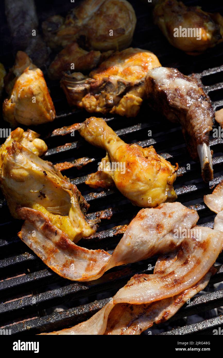 Aerial shot of grilled meat cooking on a wrought iron grill Stock Photo ...
