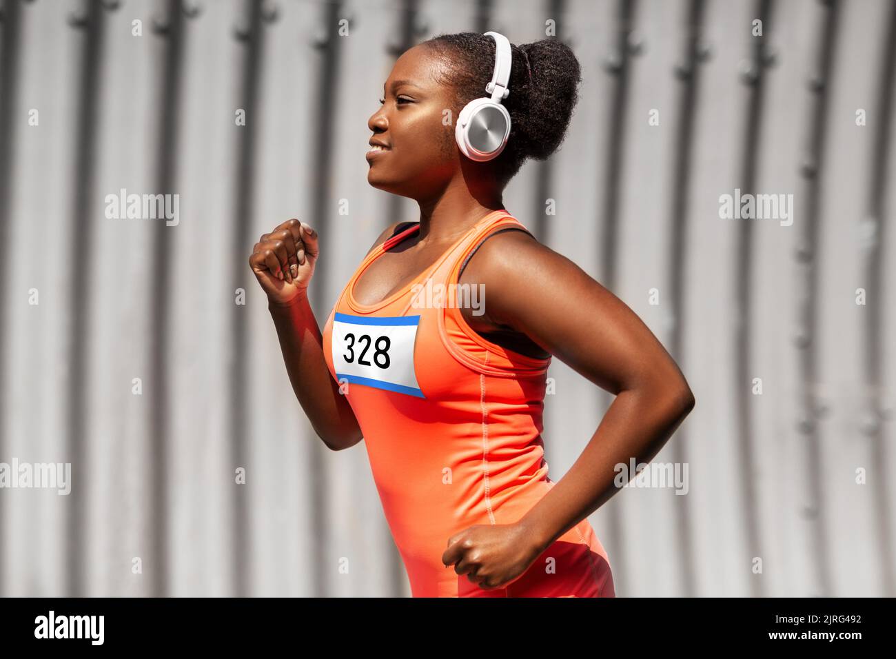 happy african american woman running marathon Stock Photo - Alamy