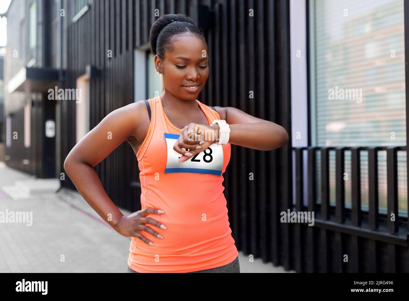 african female marathon runner with smart watch Stock Photo - Alamy