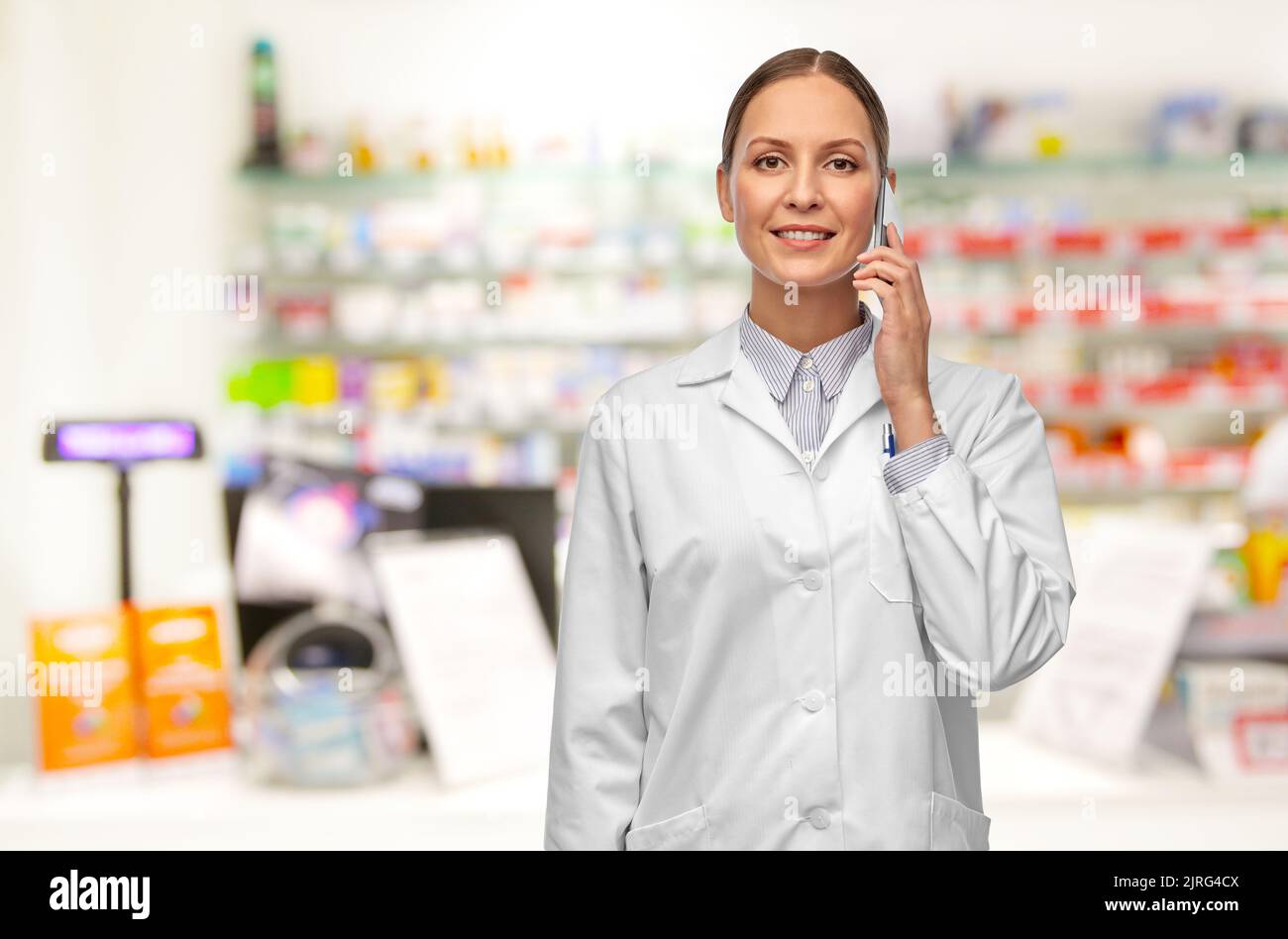 female doctoror calling on smartphone at pharmacy Stock Photo - Alamy