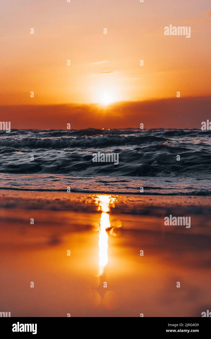A mesmerizing view of the golden sunset over the sea Stock Photo - Alamy