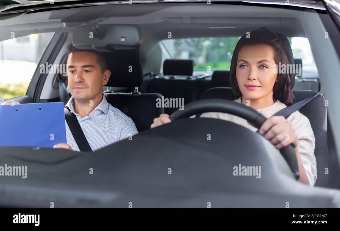 car driving school instructor and young driver Stock Photo - Alamy