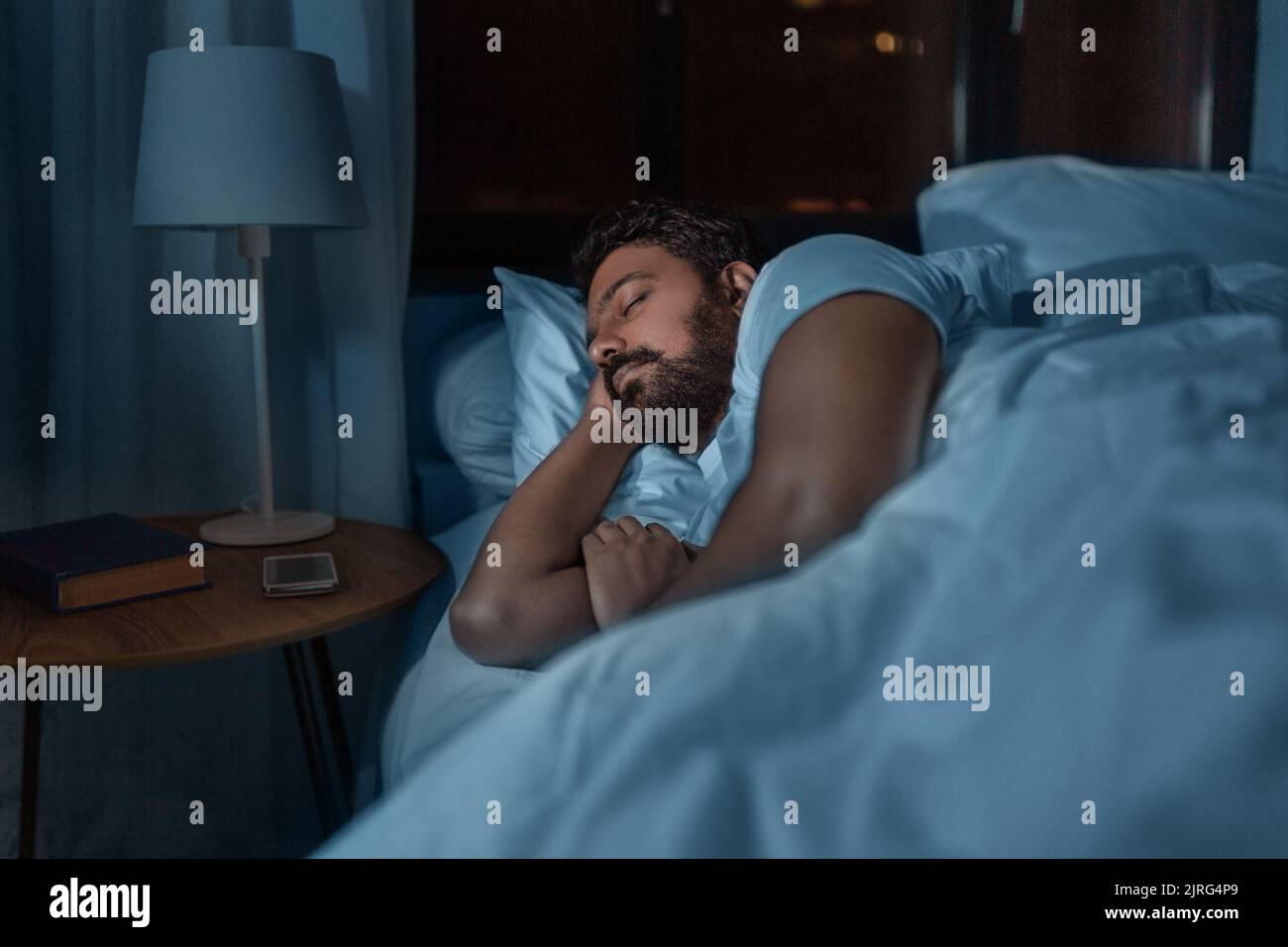 indian man sleeping in bed at home at night Stock Photo - Alamy