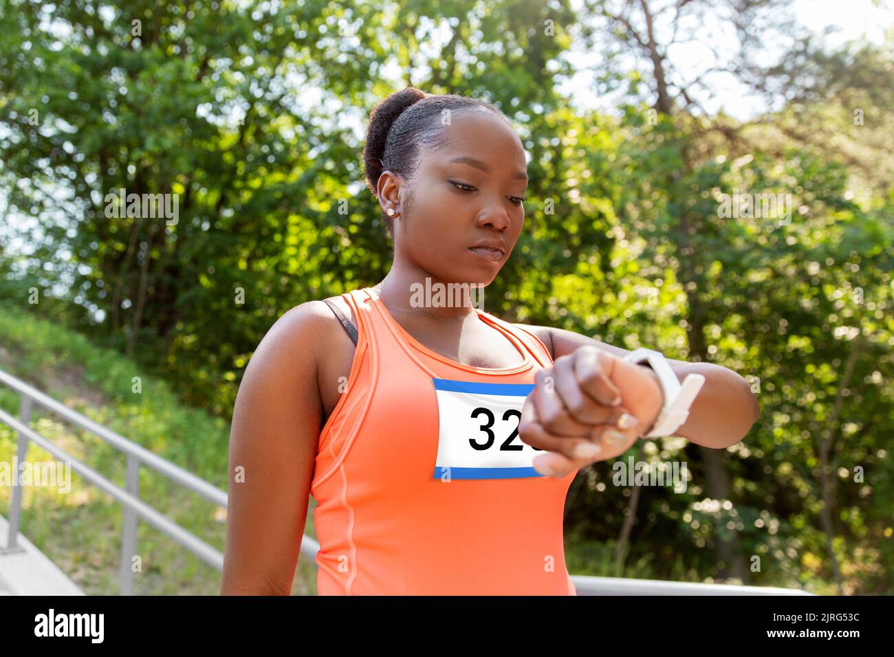 african female marathon runner with smart watch Stock Photo - Alamy
