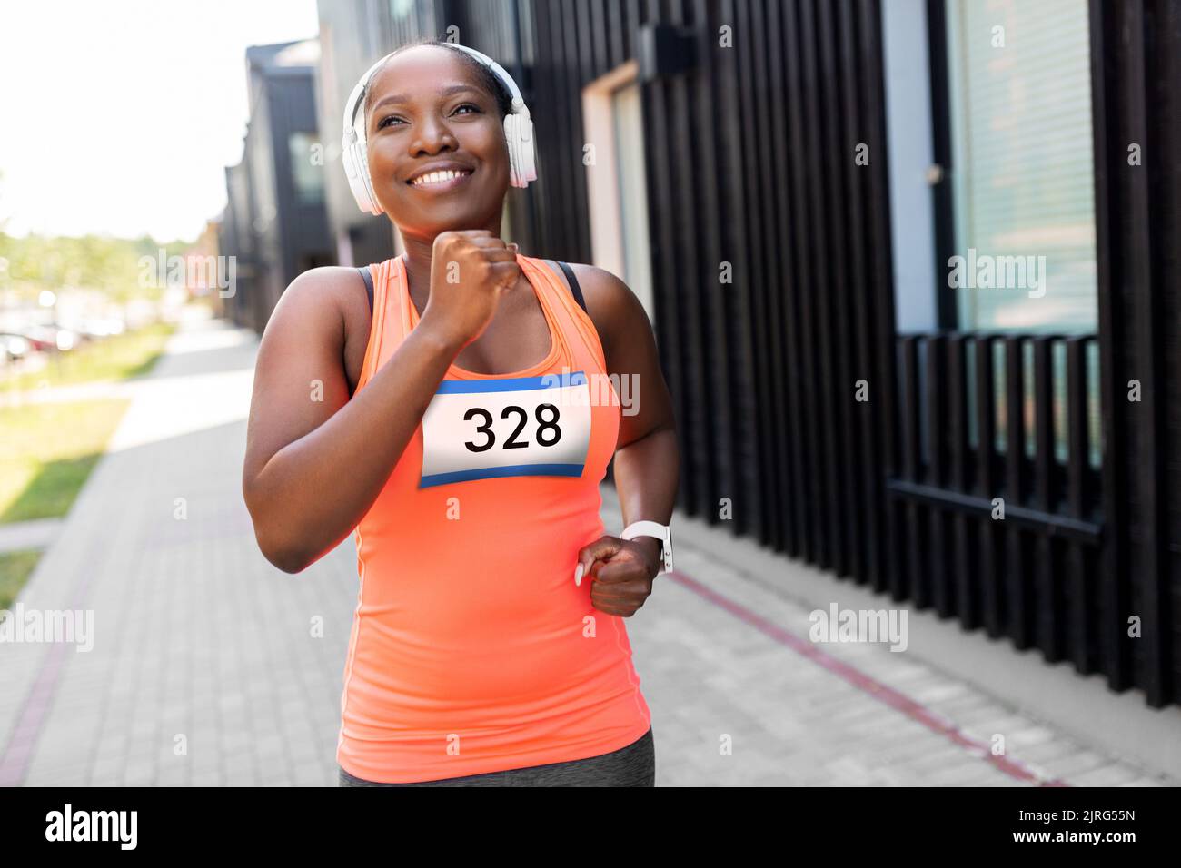 happy african american woman running marathon Stock Photo - Alamy