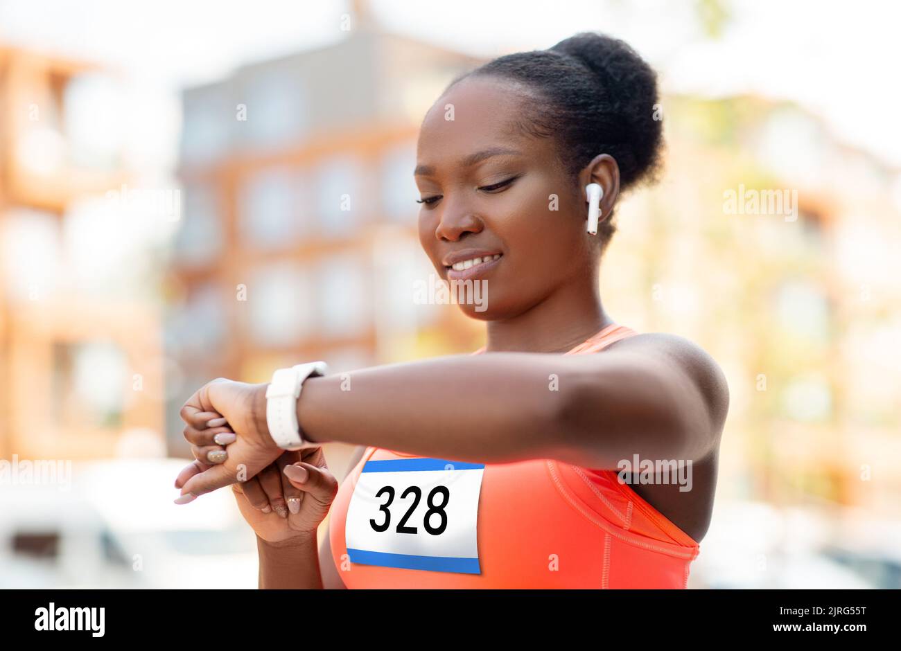 marathon runner with earphones and smart watch Stock Photo - Alamy