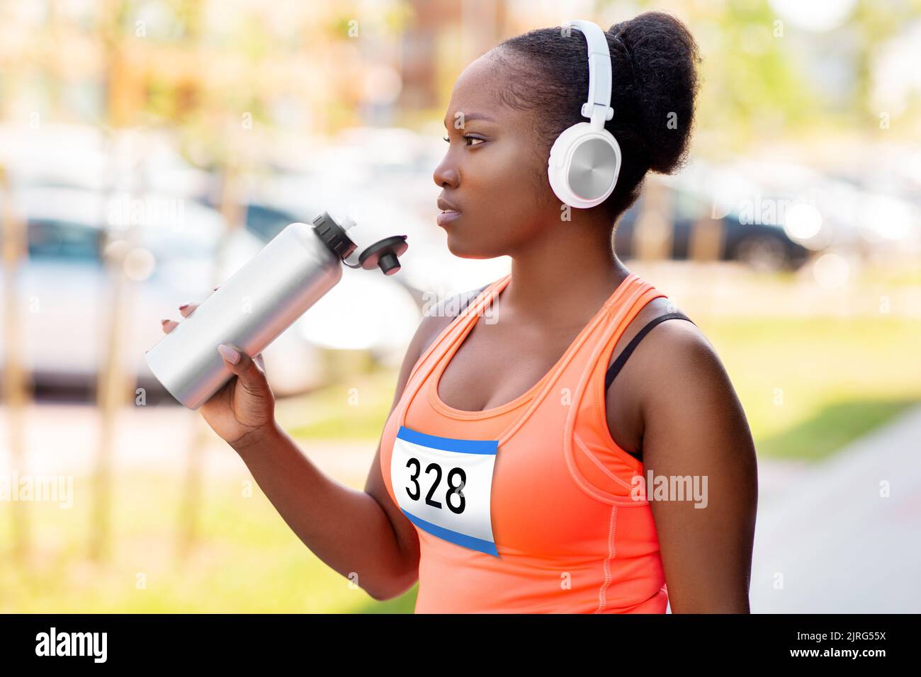african female marathon runner drinking water Stock Photo - Alamy