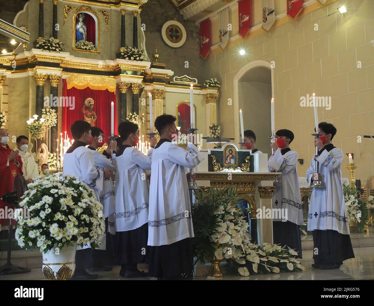 Malabon, Philippines. 24th Aug, 2022. The Knights of the Altar holding their candles during the ...