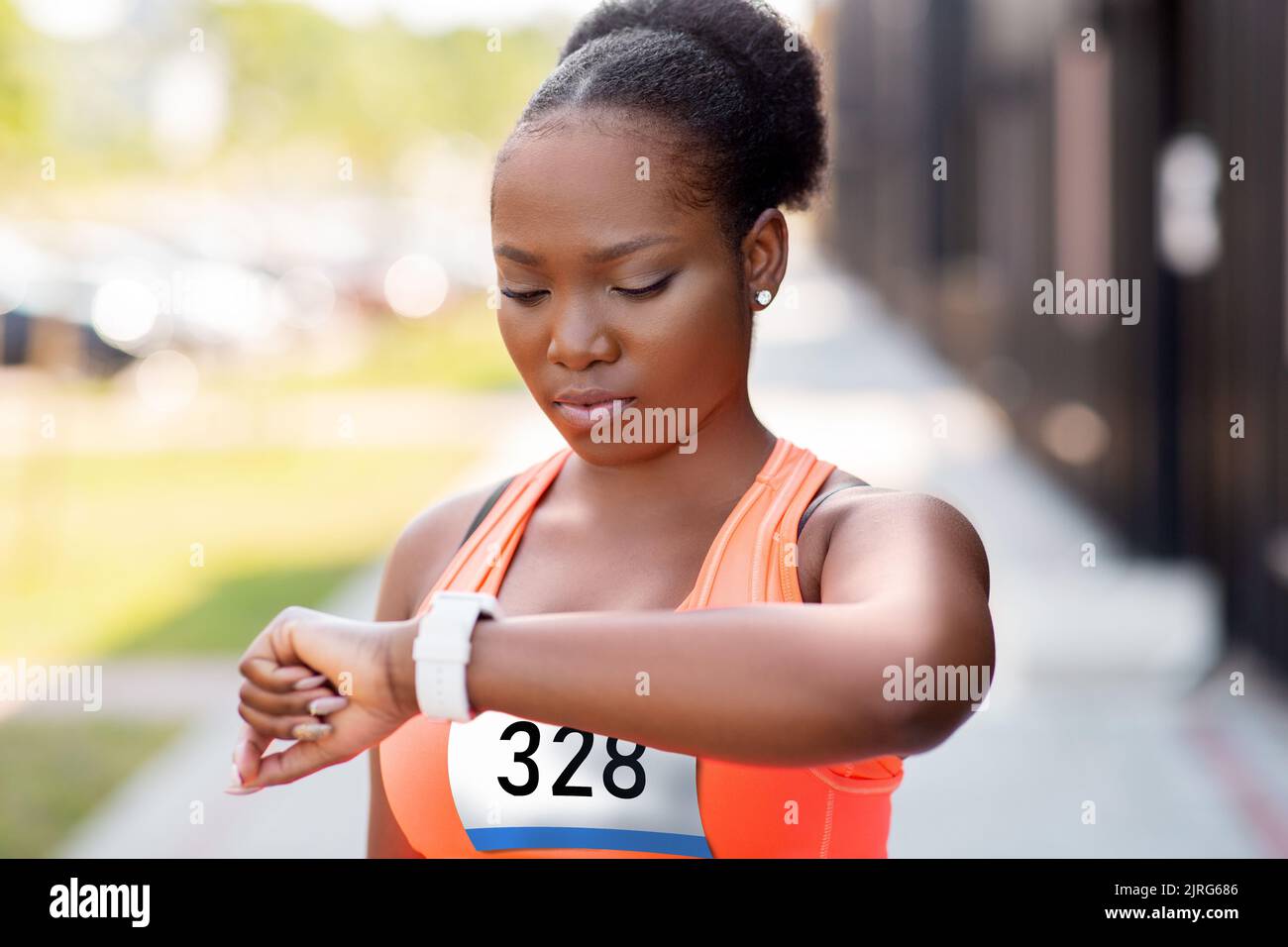 african female marathon runner with smart watch Stock Photo - Alamy