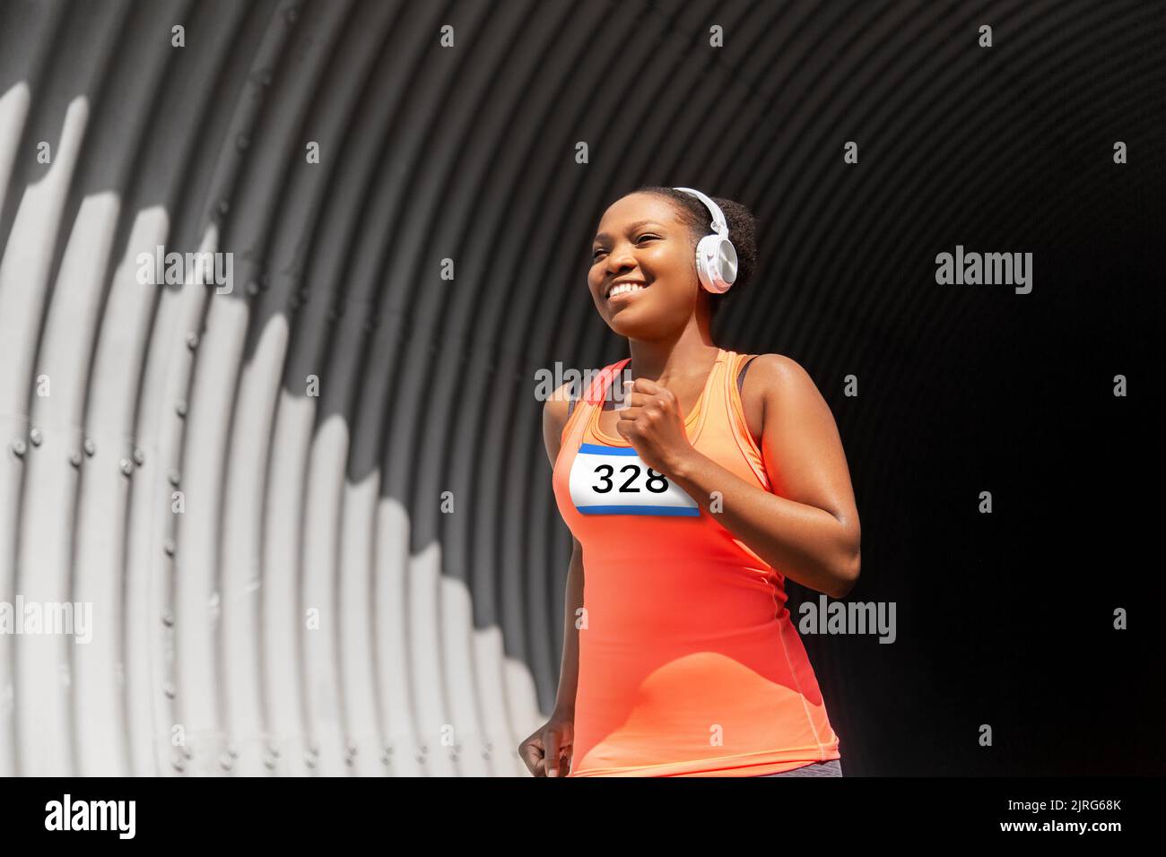 happy african american woman running marathon Stock Photo - Alamy