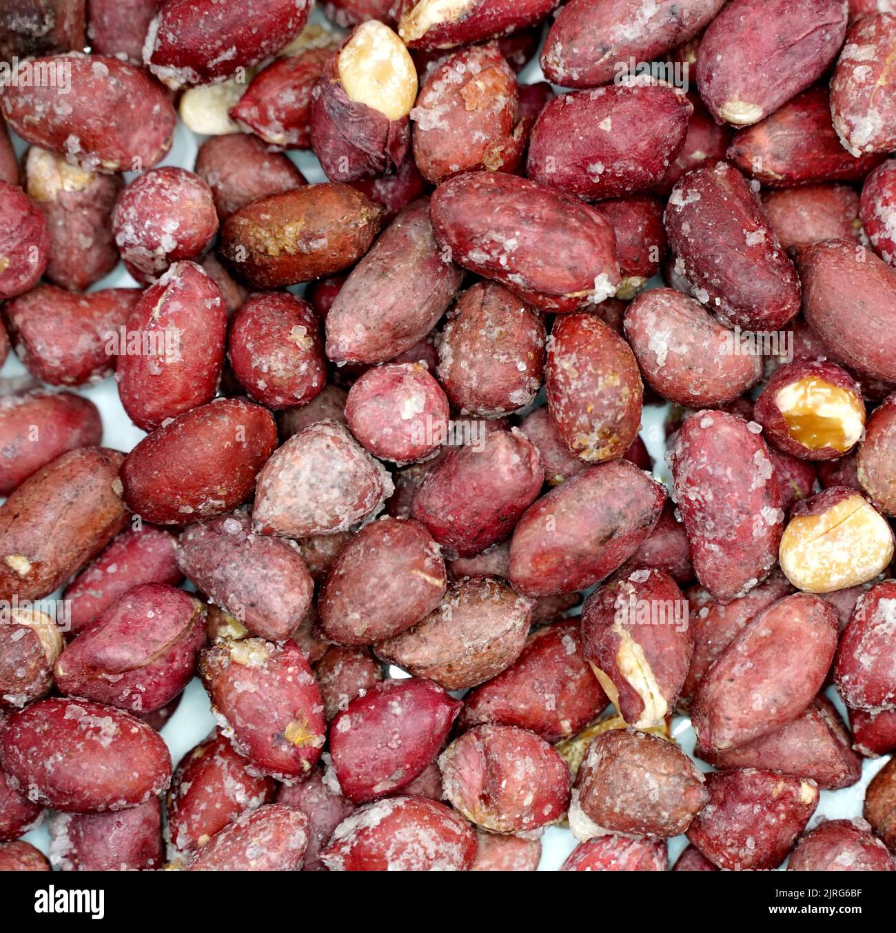 unpeeled roasted salty peanuts background Stock Photo - Alamy