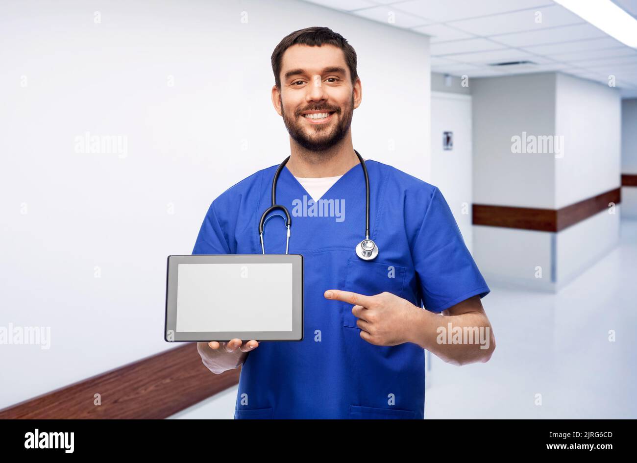 happy doctor or male nurse showing tablet computer Stock Photo - Alamy