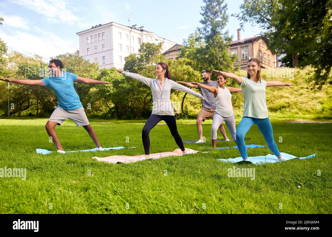 Group people doing yoga warrior hi-res stock photography and images - Alamy