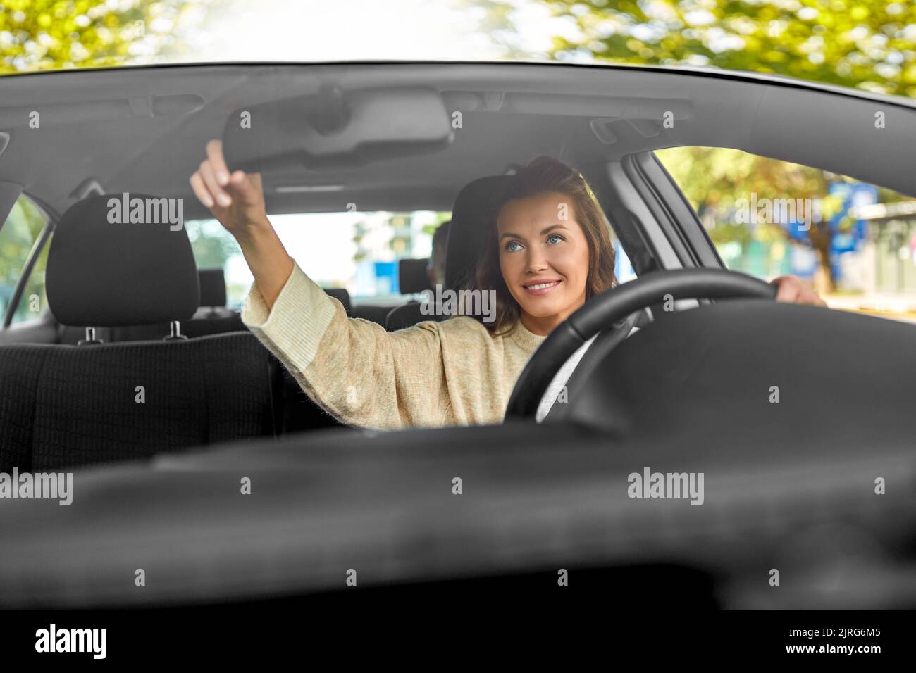 female driver driving car with male passenger Stock Photo - Alamy