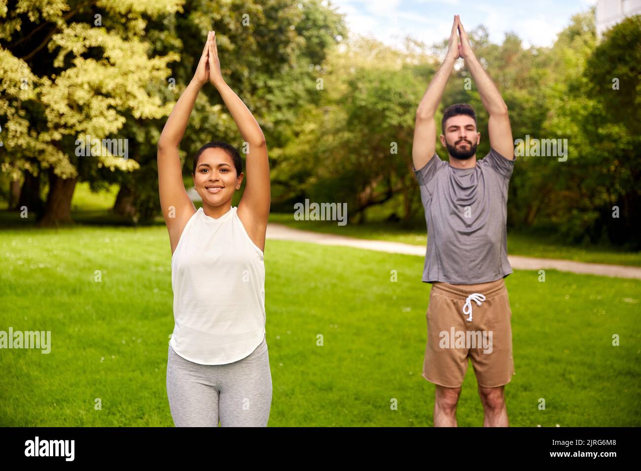 happy people doing yoga at summer park Stock Photo - Alamy