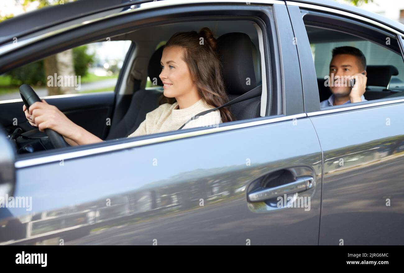 female driver driving car with male passenger Stock Photo - Alamy