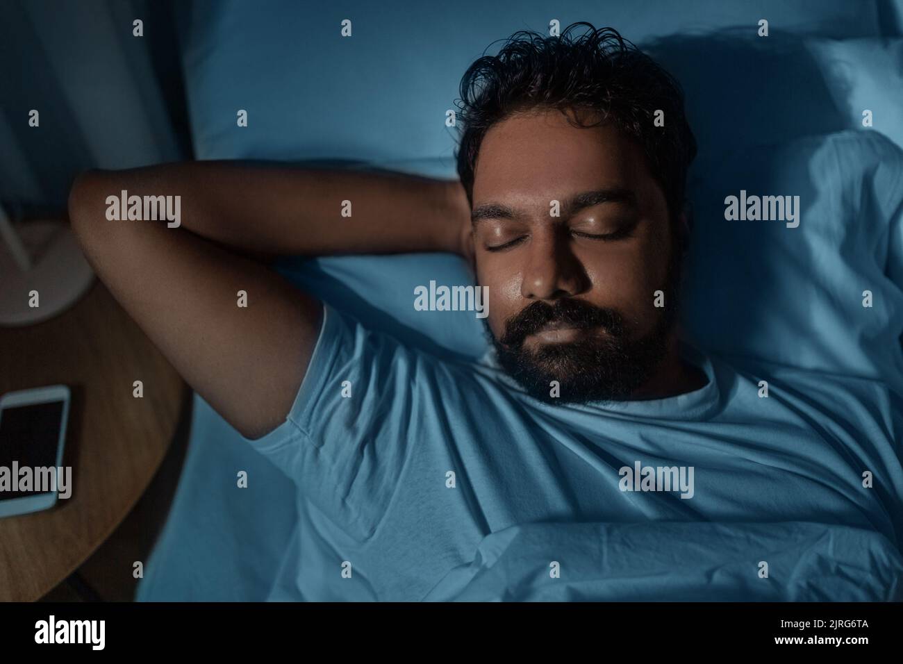 indian man sleeping in bed at home at night Stock Photo - Alamy