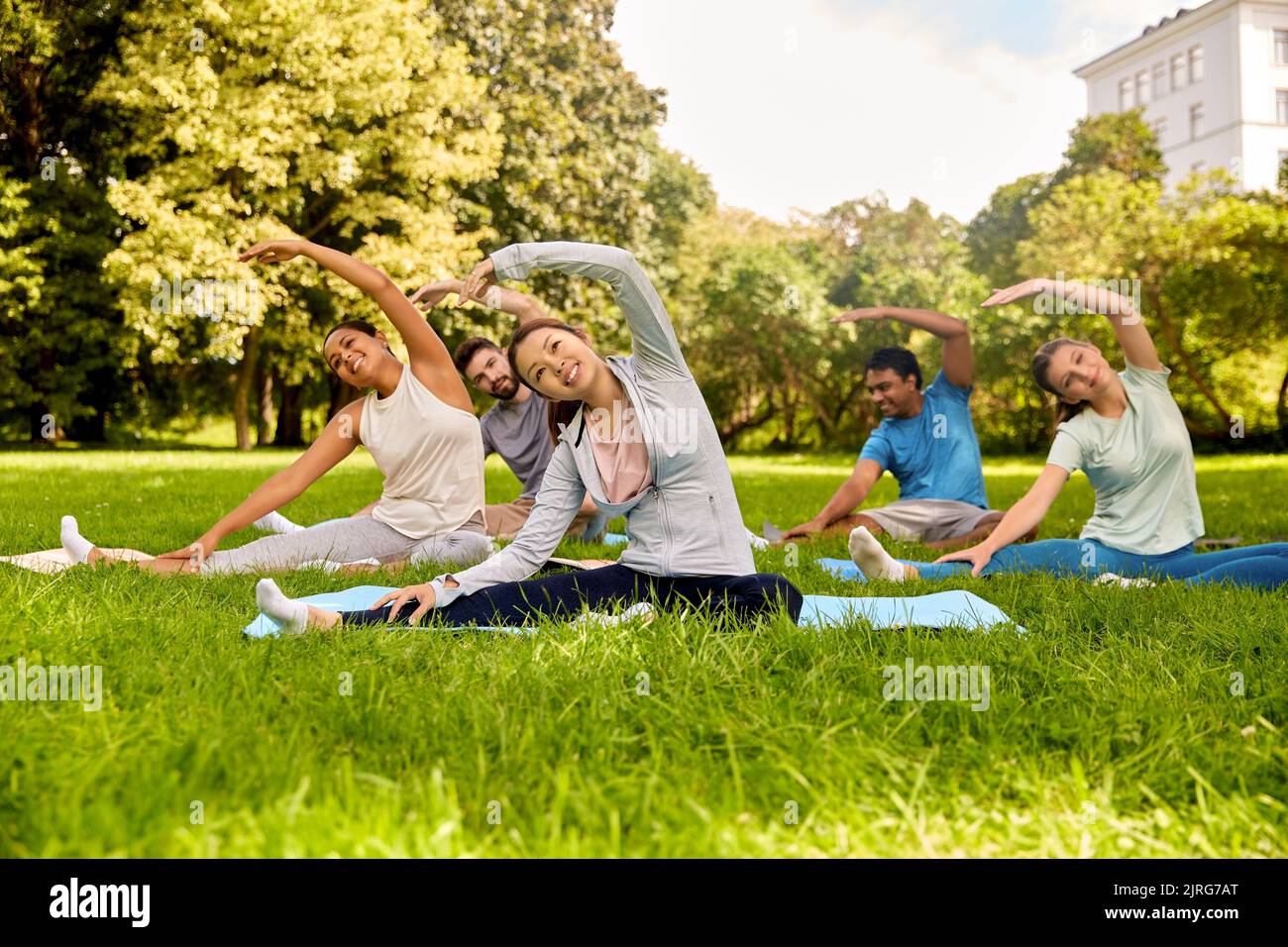 group of people exercising at summer park Stock Photo - Alamy