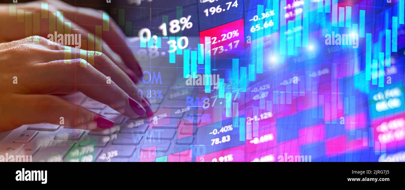 Trader at home working on laptop analyzing indexes, financial chart, graphs, investment and ...