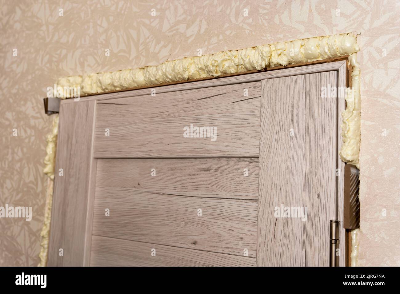 dried Construction mounting foam between the door frame and the wall ...